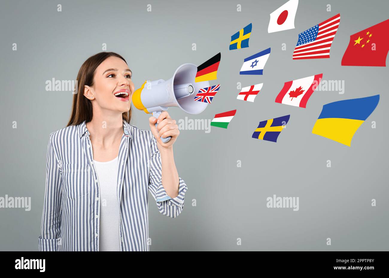 Portrait of interpreter with megaphone and flags of different countries ...
