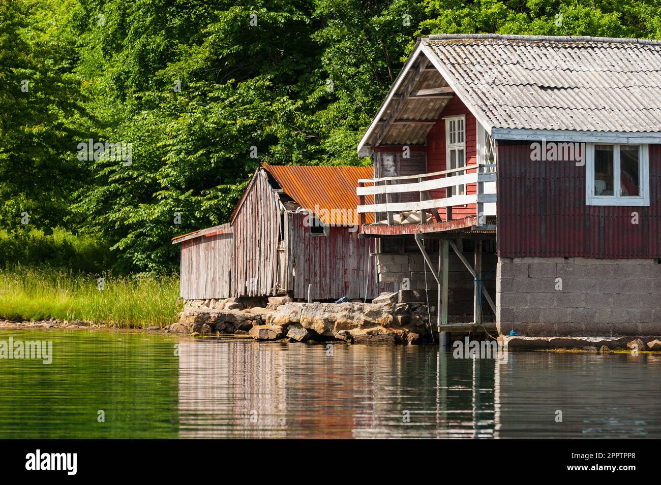 Old and worn down wooden boat houses Stock Photo - Alamy