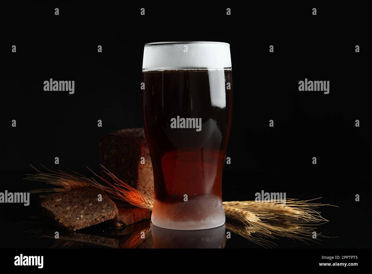 Delicious cold kvass, bread and spikes on black background Stock Photo ...