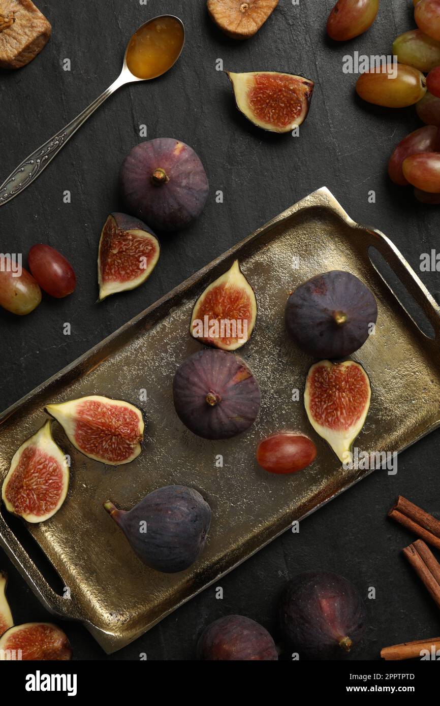 Flat lay composition with ripe figs on black slate table Stock Photo ...