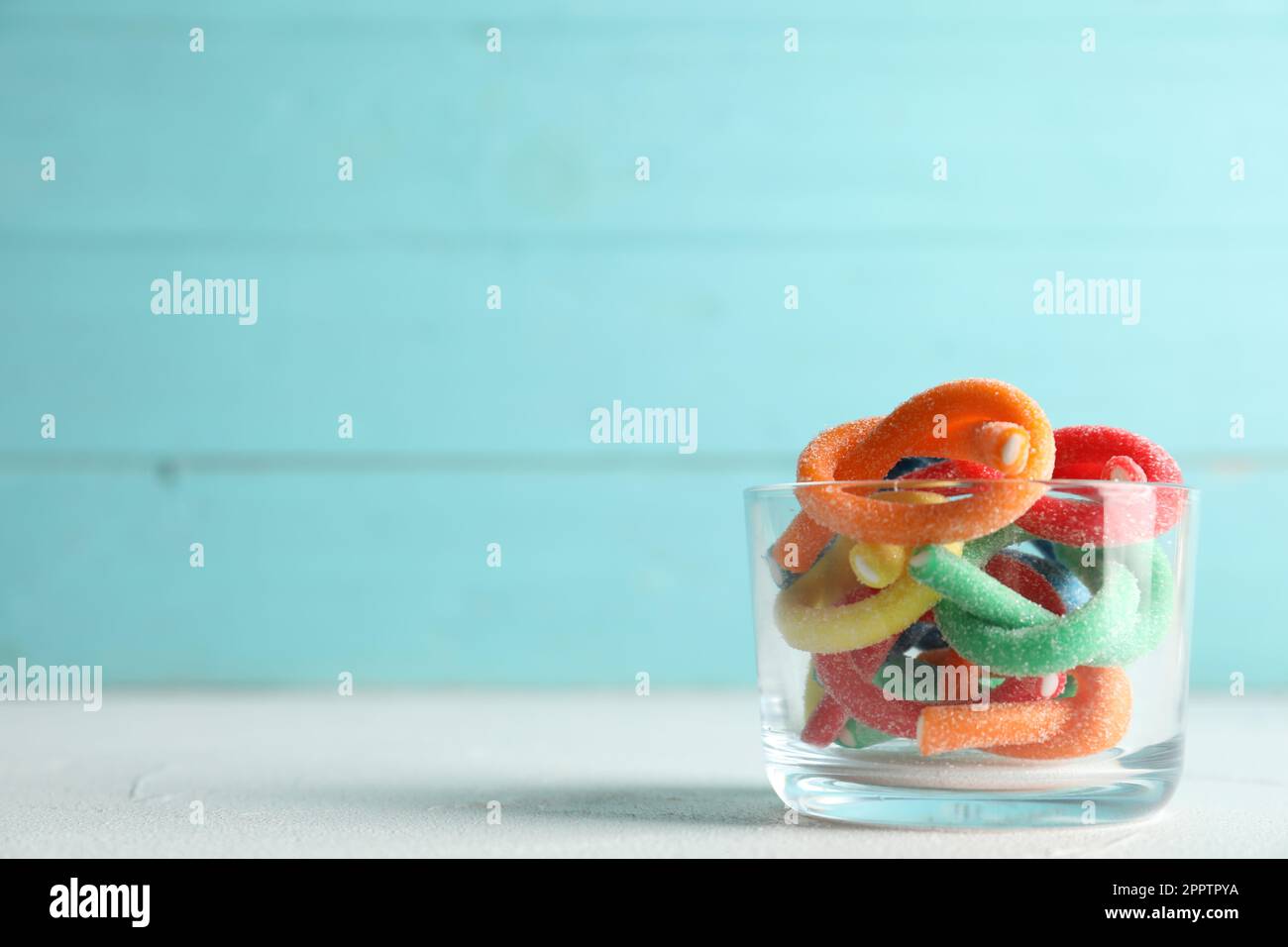 Delicious bright candies on white table. Space for text Stock Photo - Alamy