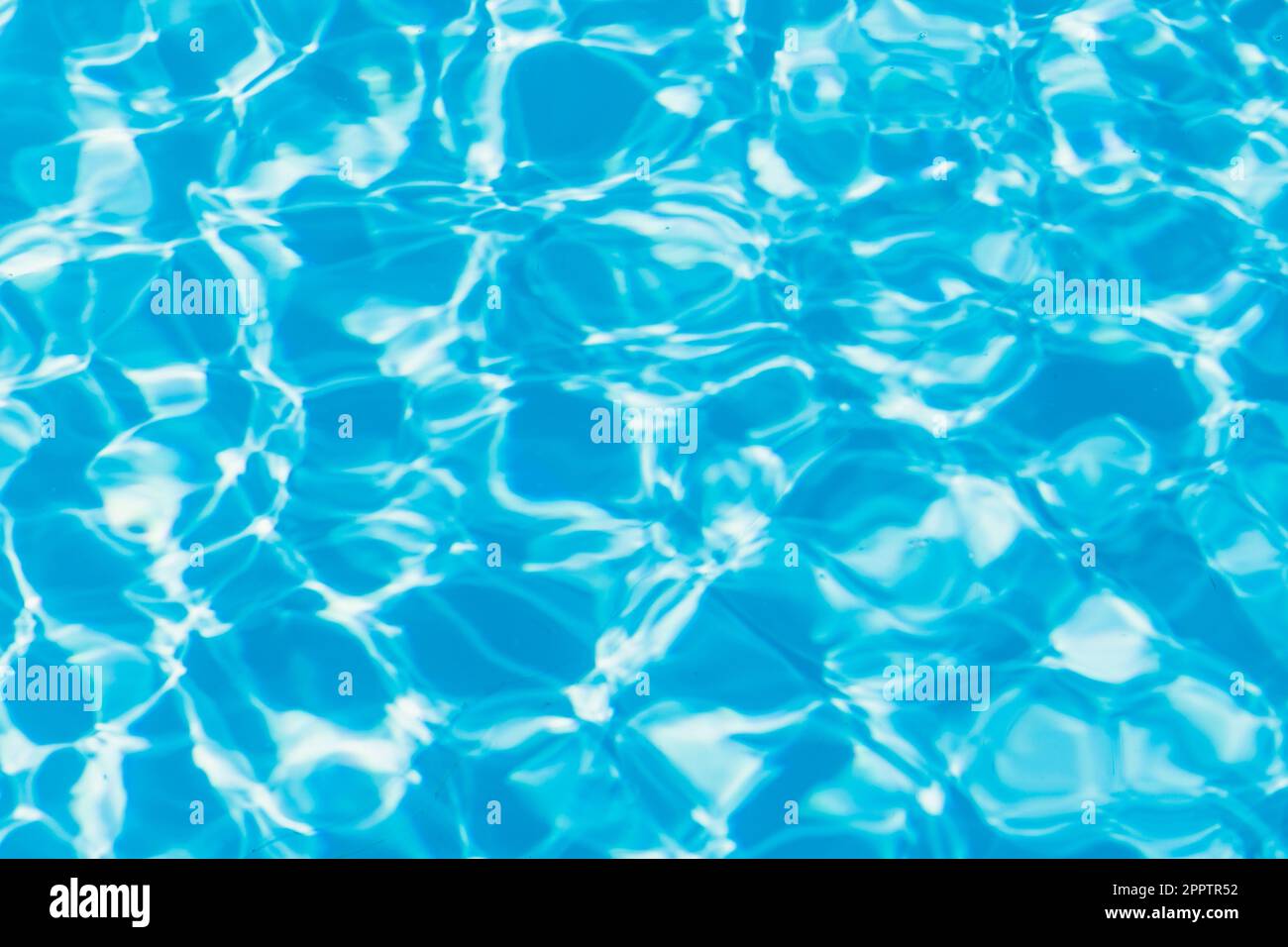 Blue pool water with sun reflections background Stock Photo - Alamy
