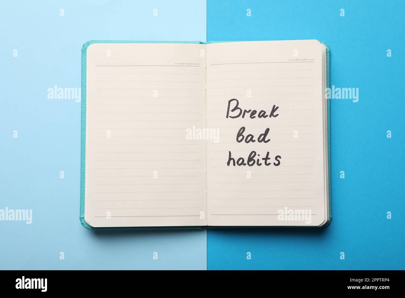 Open notebook with phrase Break Bad Habits on light blue background ...
