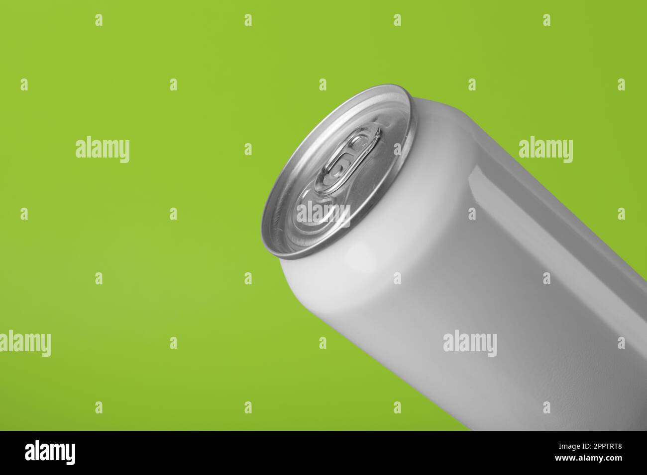 White can of energy drink on light green background, closeup. Space for ...