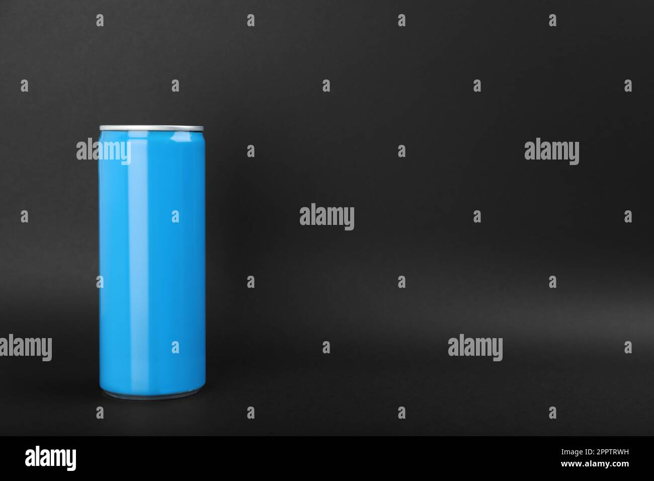 Light blue can of energy drink on black background. Space for text ...