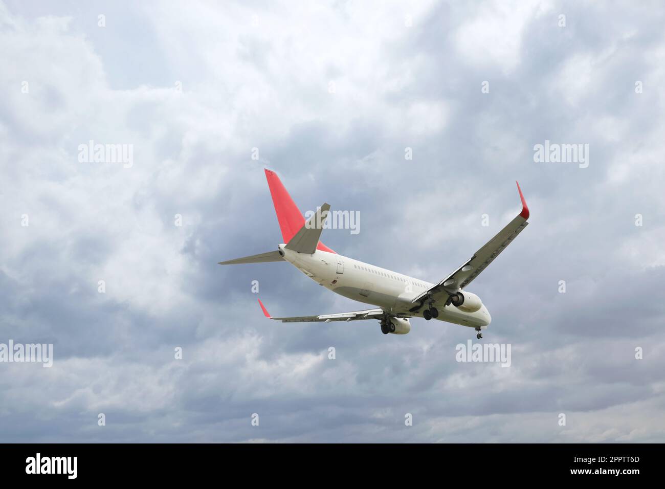 Airplane flying high in cloudy sky. Modern aircraft Stock Photo - Alamy