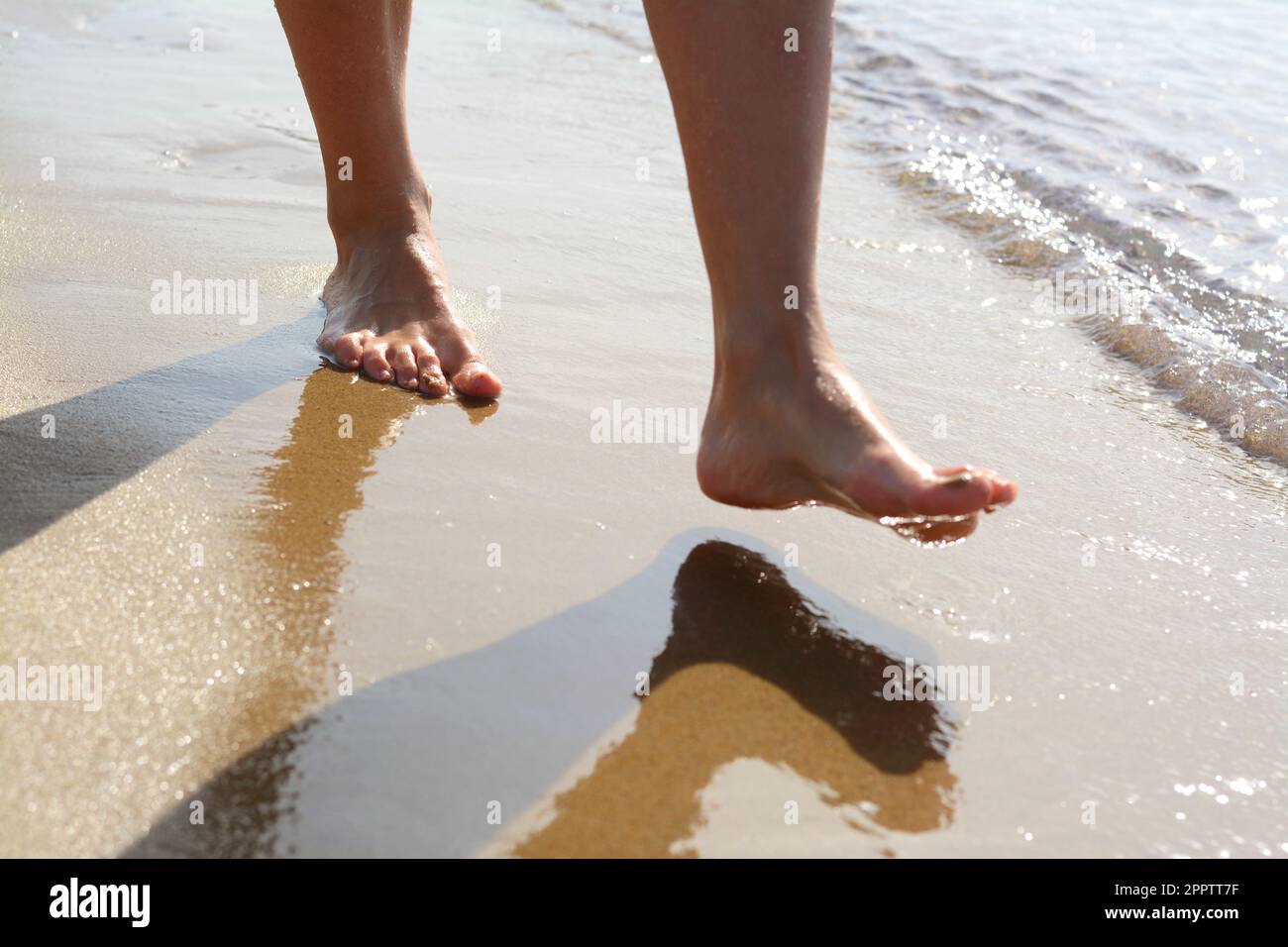 Woman legs on sandy shore hi-res stock photography and images - Alamy