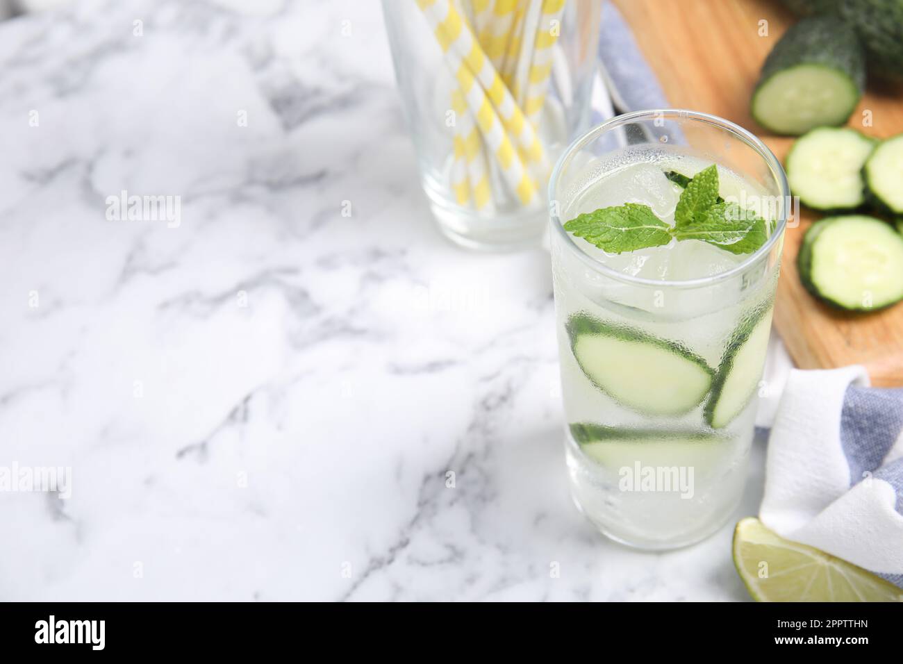 Glass of refreshing cucumber water with mint on white marble table, space for text Stock Photo ...