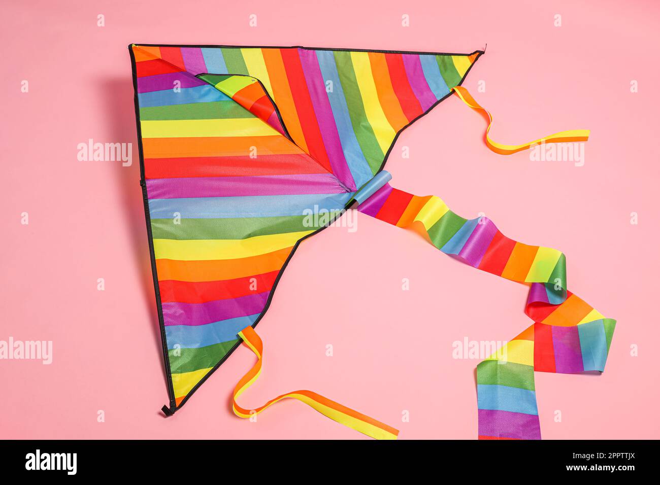 Beautiful bright rainbow kite on pink background Stock Photo - Alamy