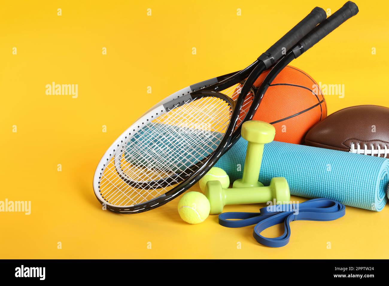 Set of different sports equipment on yellow background Stock Photo - Alamy