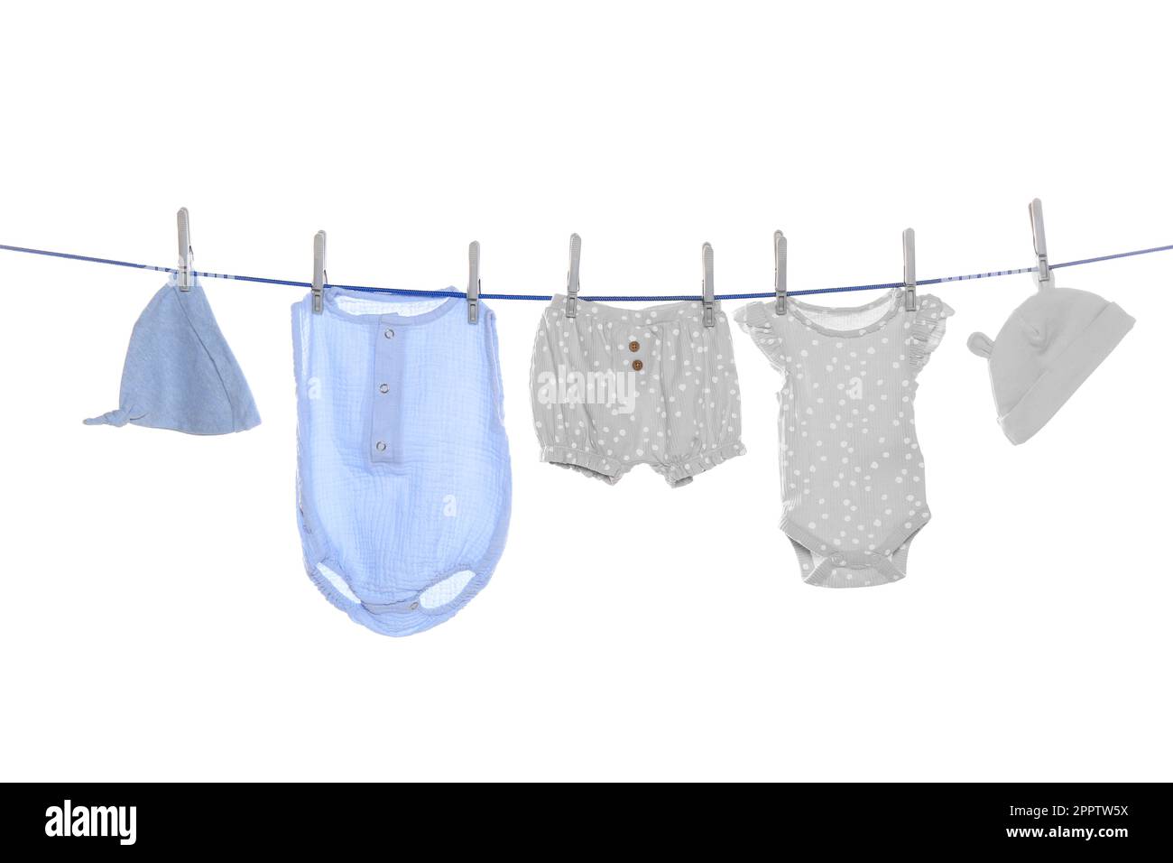 Different baby clothes drying on laundry line against white background ...