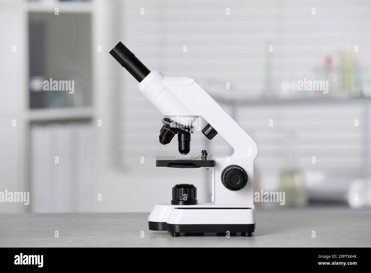 Modern medical microscope on grey table in laboratory Stock Photo - Alamy