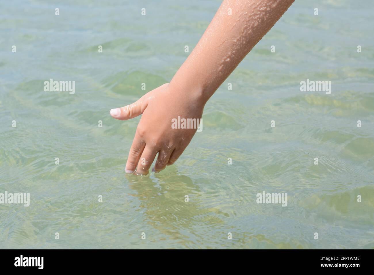 Child touching water hi-res stock photography and images - Alamy