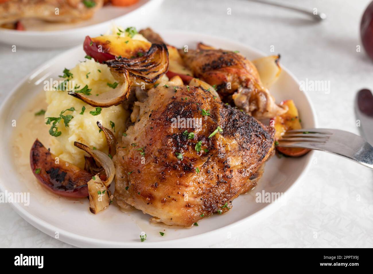 Oven baked chicken shanks with mashed potatoes, roasted onions and ...