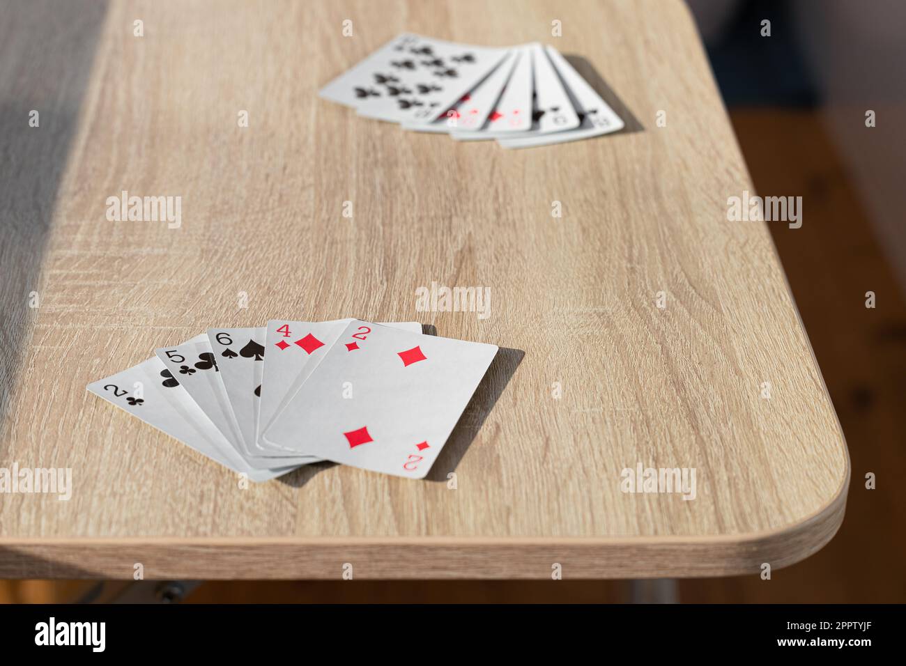 playing cards of various suits lie on the table. playing card on the ...