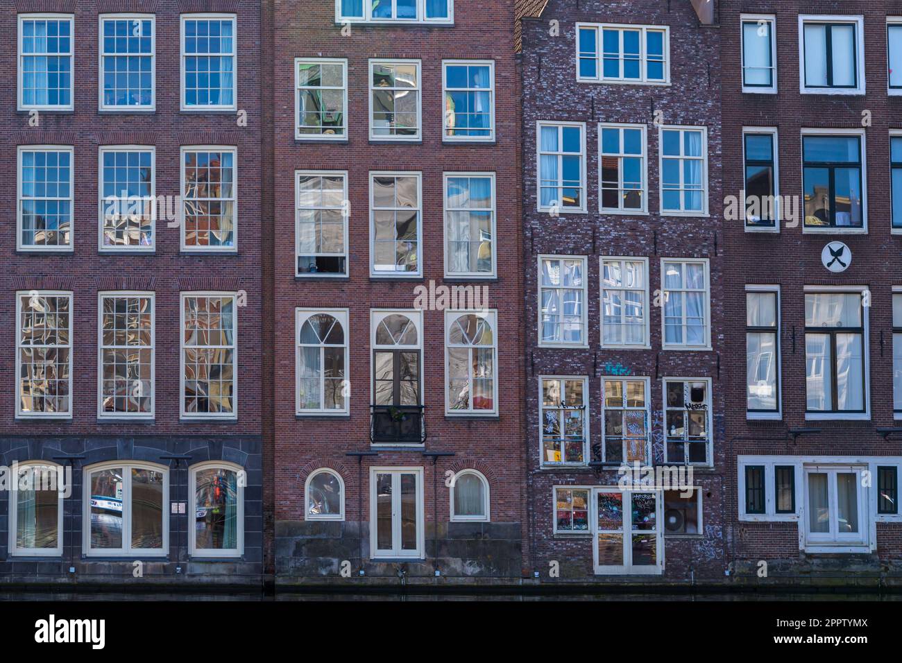 Dancing houses, buildings with reflections in windows by Damrak canal ...