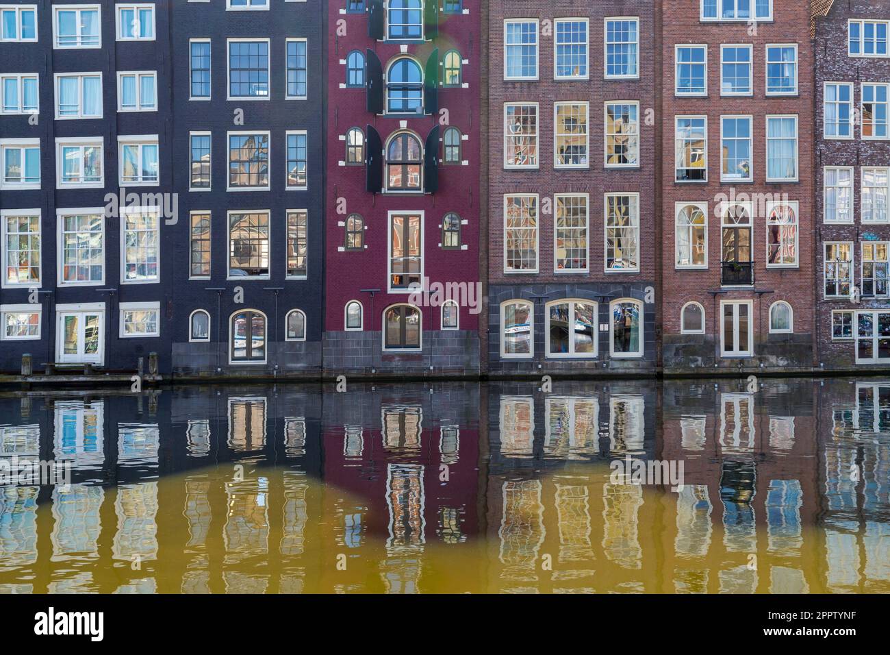 Dancing houses, buildings with reflections in windows by Damrak canal ...