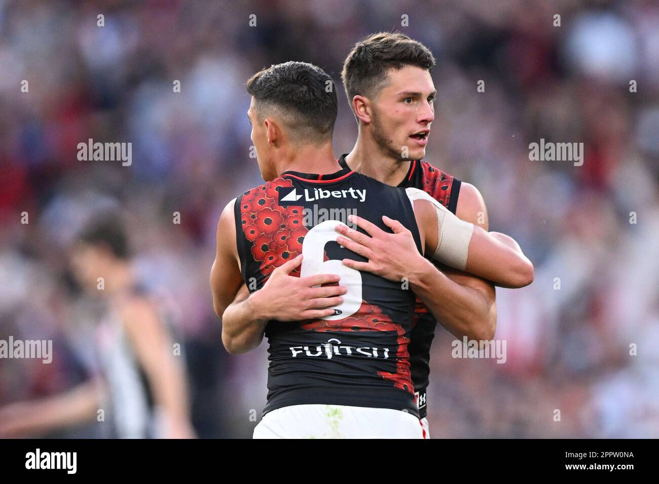 Archie Perkins of Essendon (right) celebrates with team mates after ...