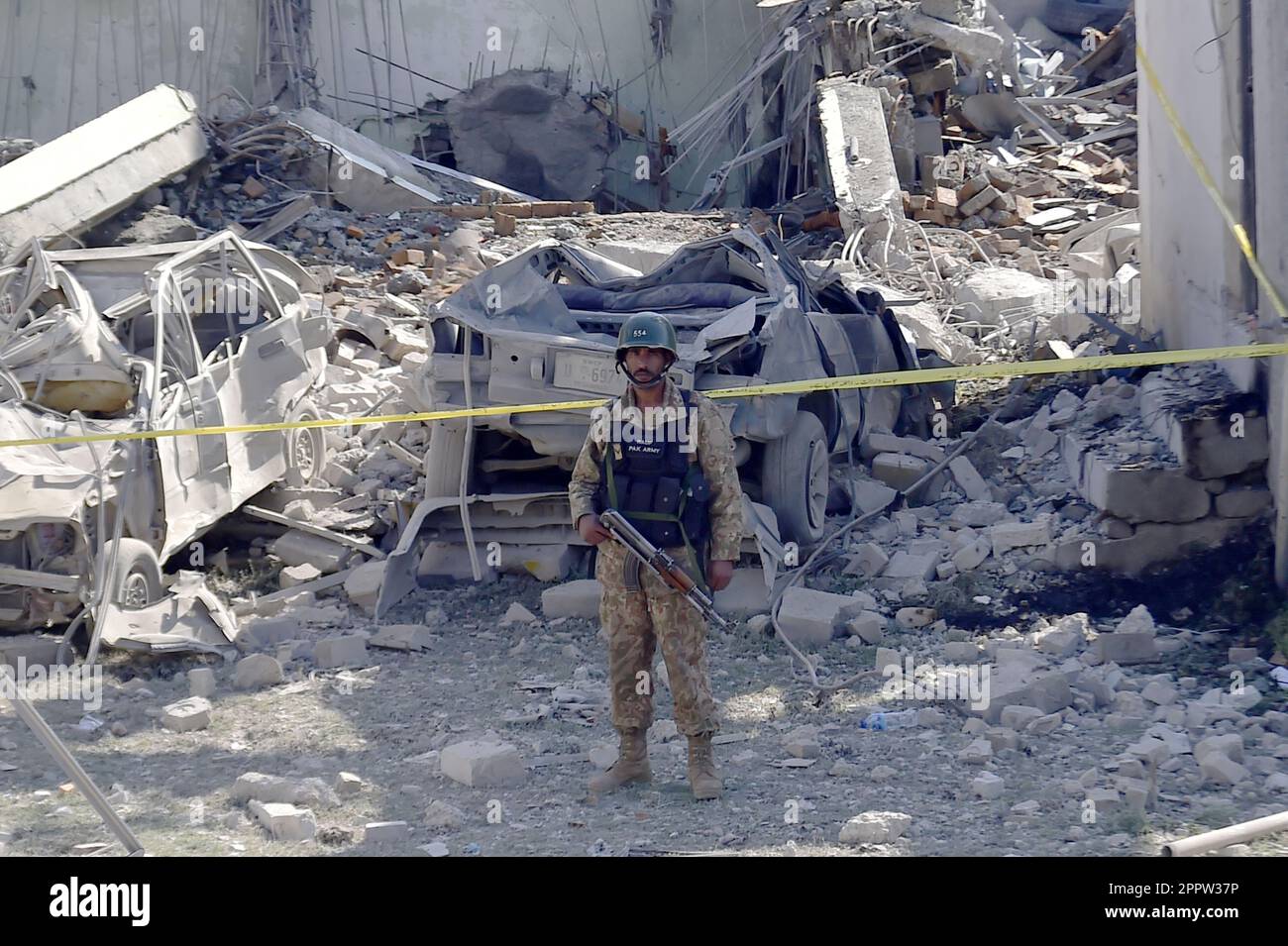 Swat. 25th Apr, 2023. A soldier stands guard in a damaged compound of ...