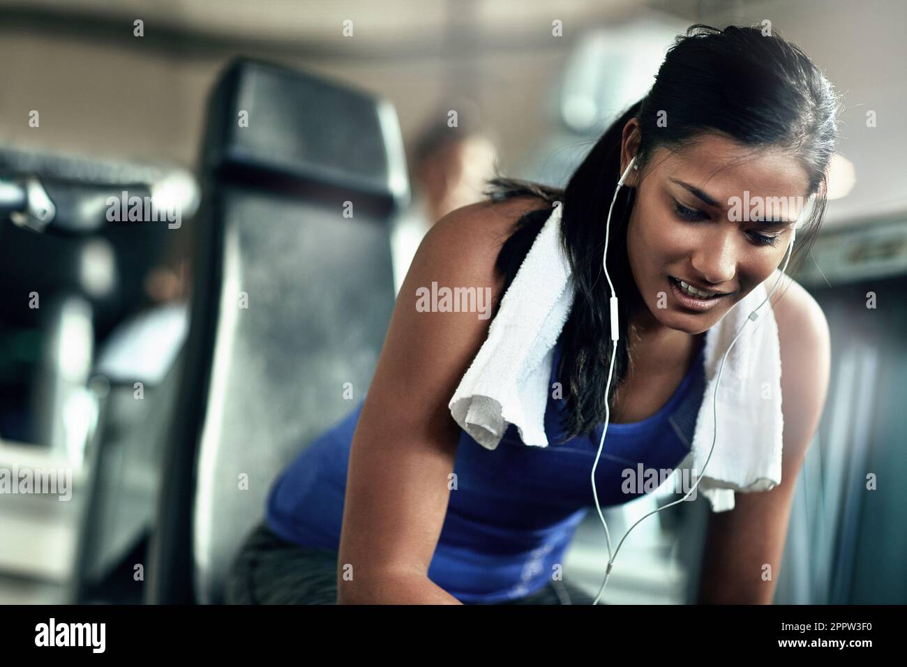 Break for a breather. a young woman taking a break from her workout at ...