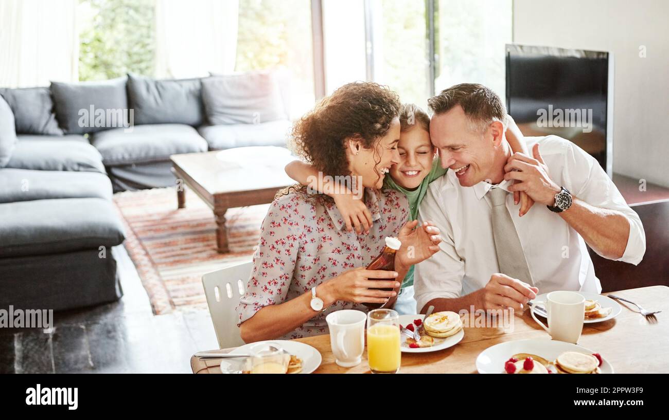 Breakfast is time for them to connect as a family. a family having ...
