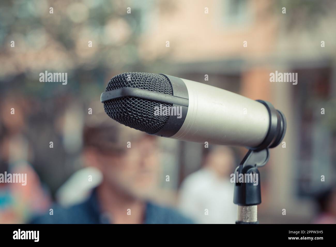 Close up of microphone in public place with blur background Stock Photo ...