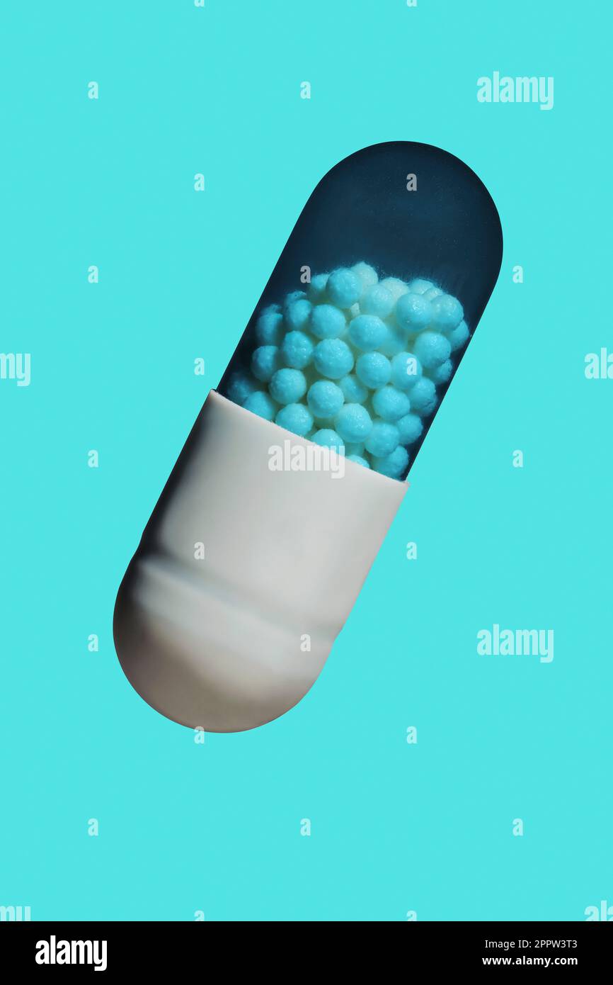 Close up granules inside medicine capsule on blue background Stock ...