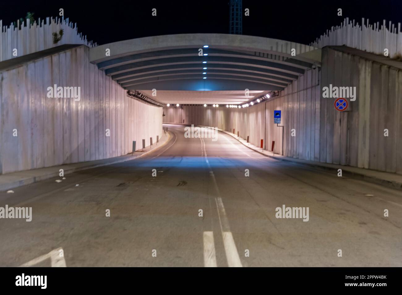 Road, highway, tunnel, underpass illuminated by artificial lights at ...