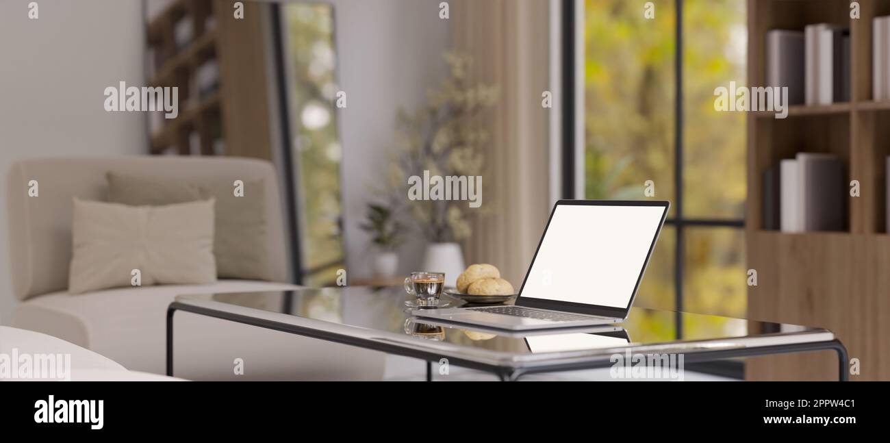 Close-up side view of a laptop white screen mockup on a modern coffee ...
