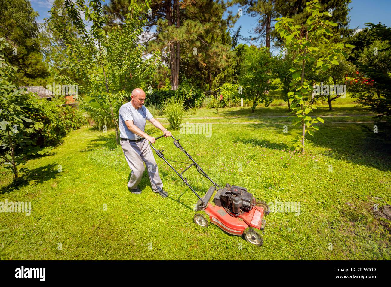 Cutting grass manually hi-res stock photography and images - Alamy