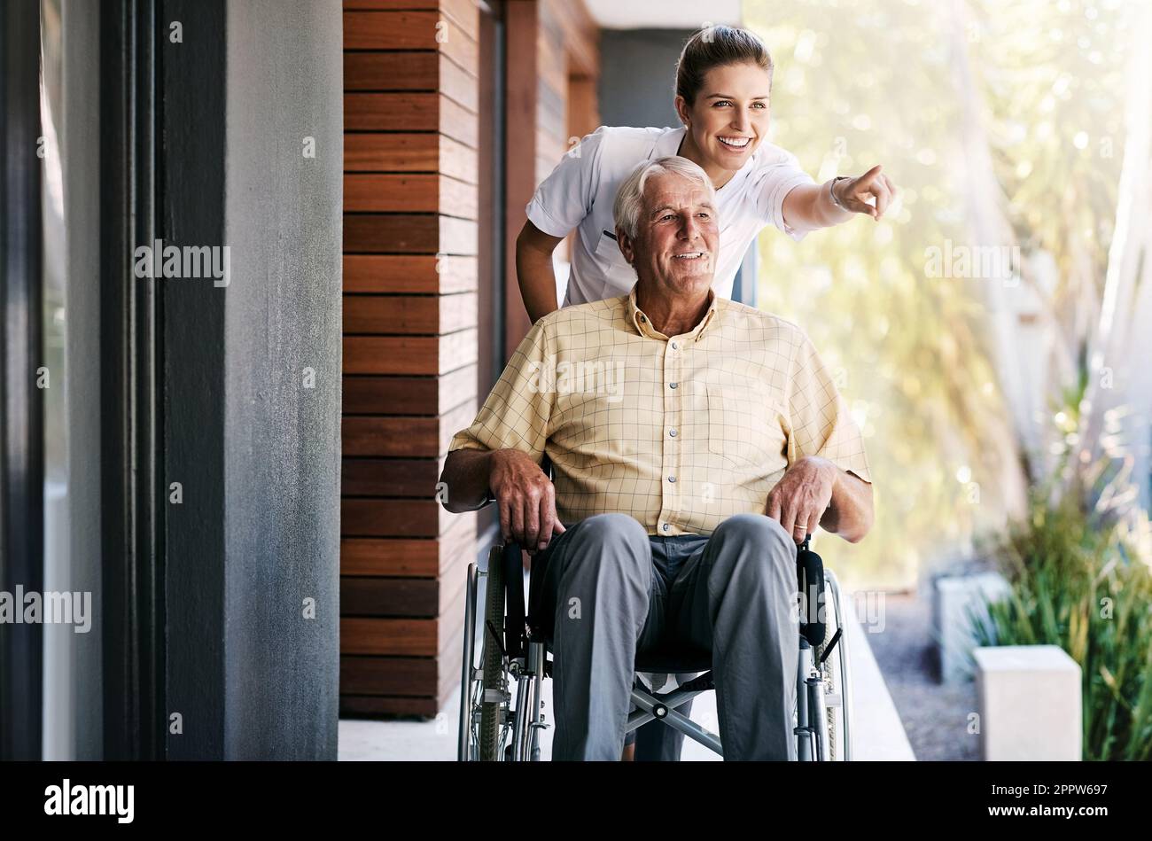 Showing a new patient the facilities around the centre. a nurse caring for a senior patient in a ...