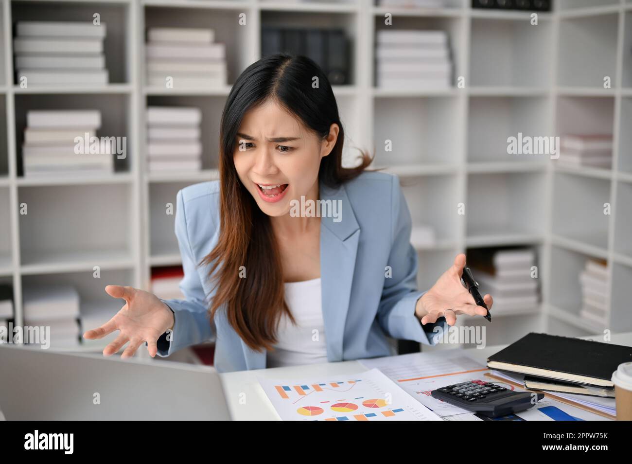 Furious and angry millennial Asian businesswoman or female boss ...