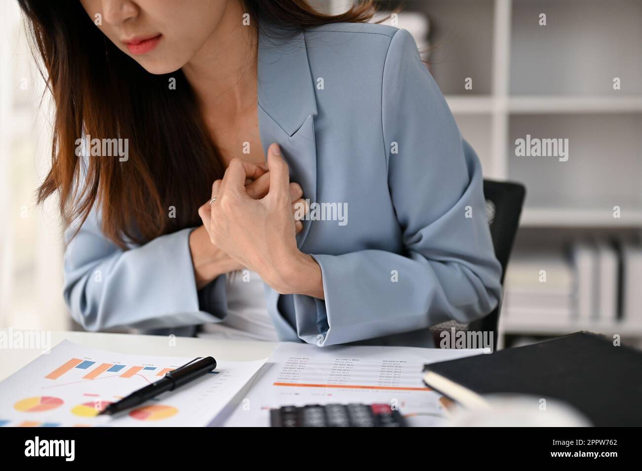 Close-up image of an unwell millennial Asian businesswoman feeling ...
