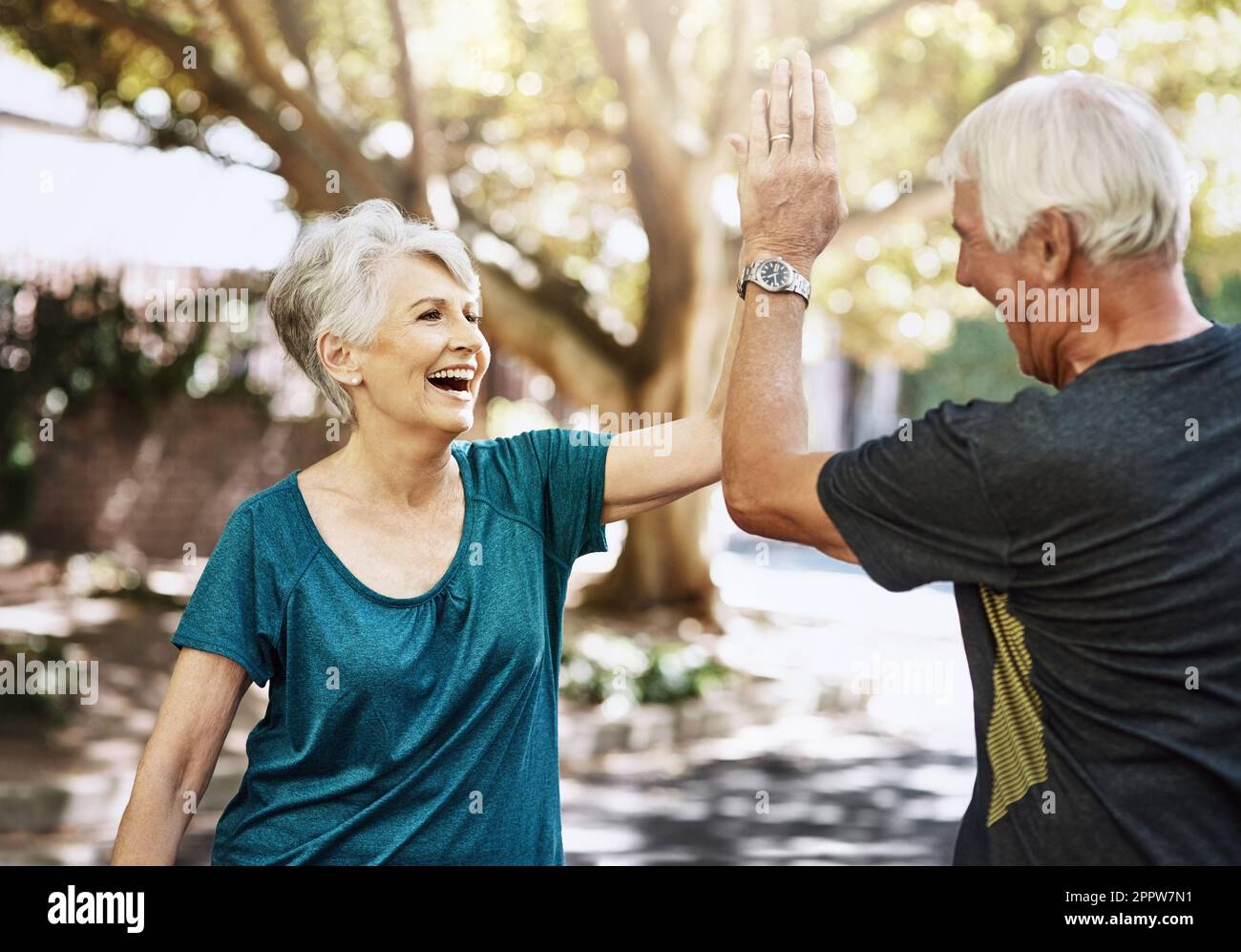 Keeping each other motivated. a senior couple high fiving each other ...