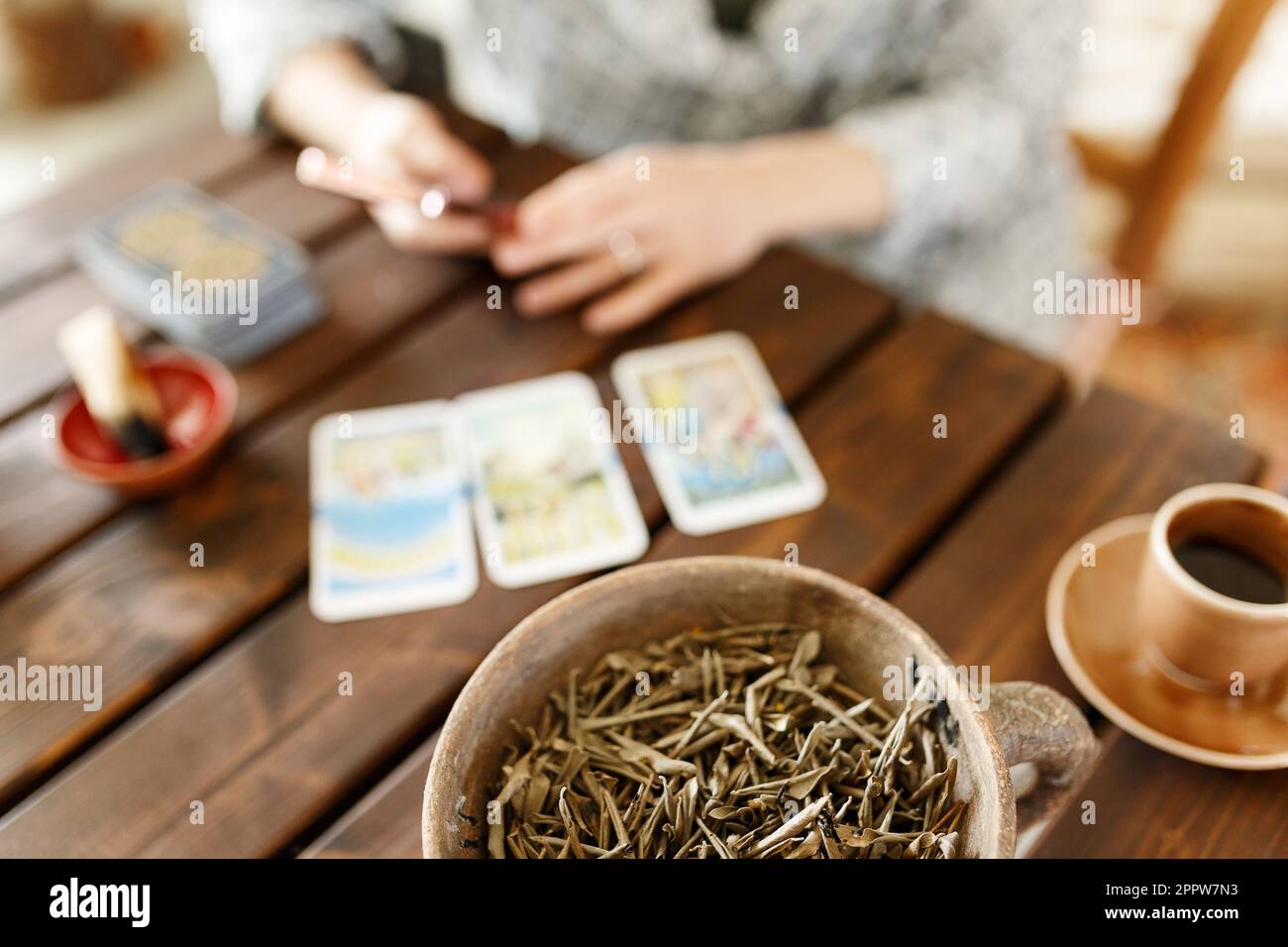 Fortune teller with tarot cards on table near burning candle.Tarot ...