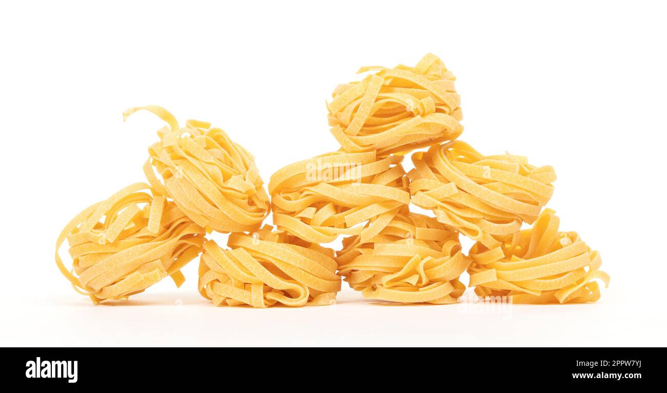 Tagliatelle pasta rolls on a white background Stock Photo - Alamy