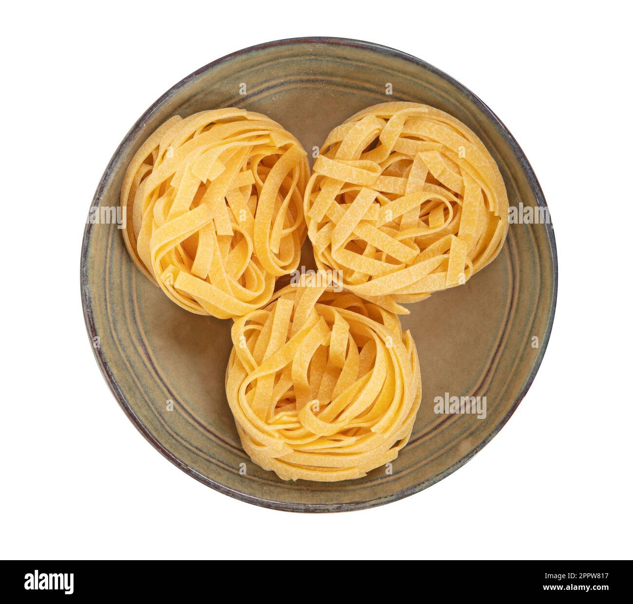 Tagliatelle pasta rolls on a white background Stock Photo - Alamy