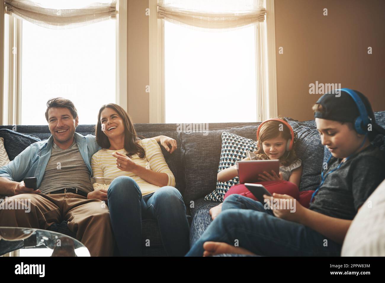 Staying entertained all weekend long. a couple watching tv while their ...