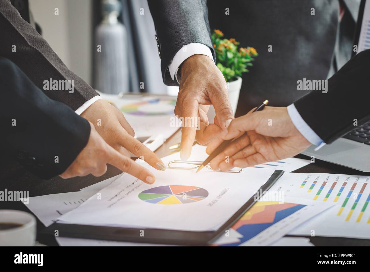 Business team analyzing income charts and graphs with modern laptop ...