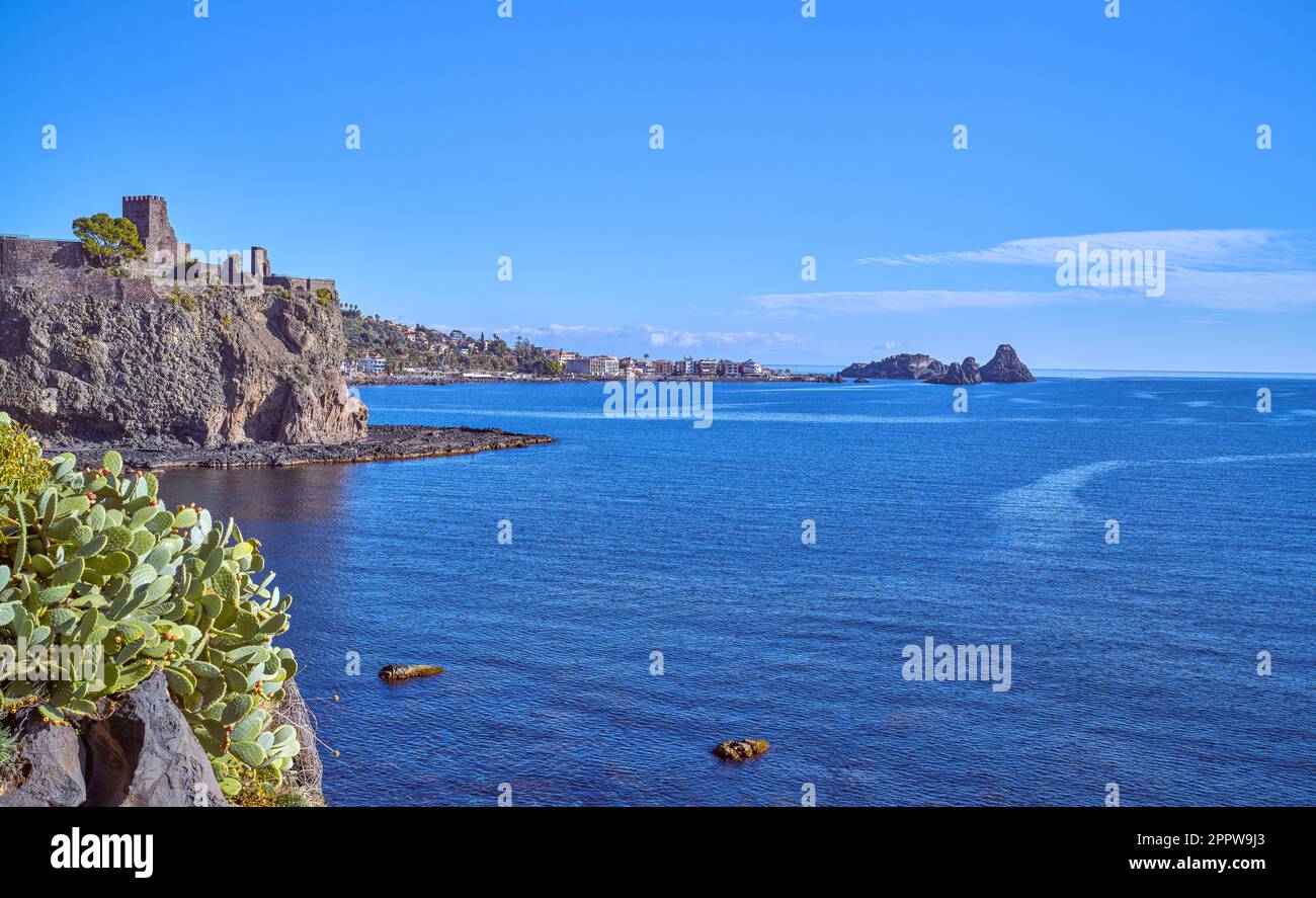 Italy, Aci Castello, panoramic view of the coast with the stacks of the ...