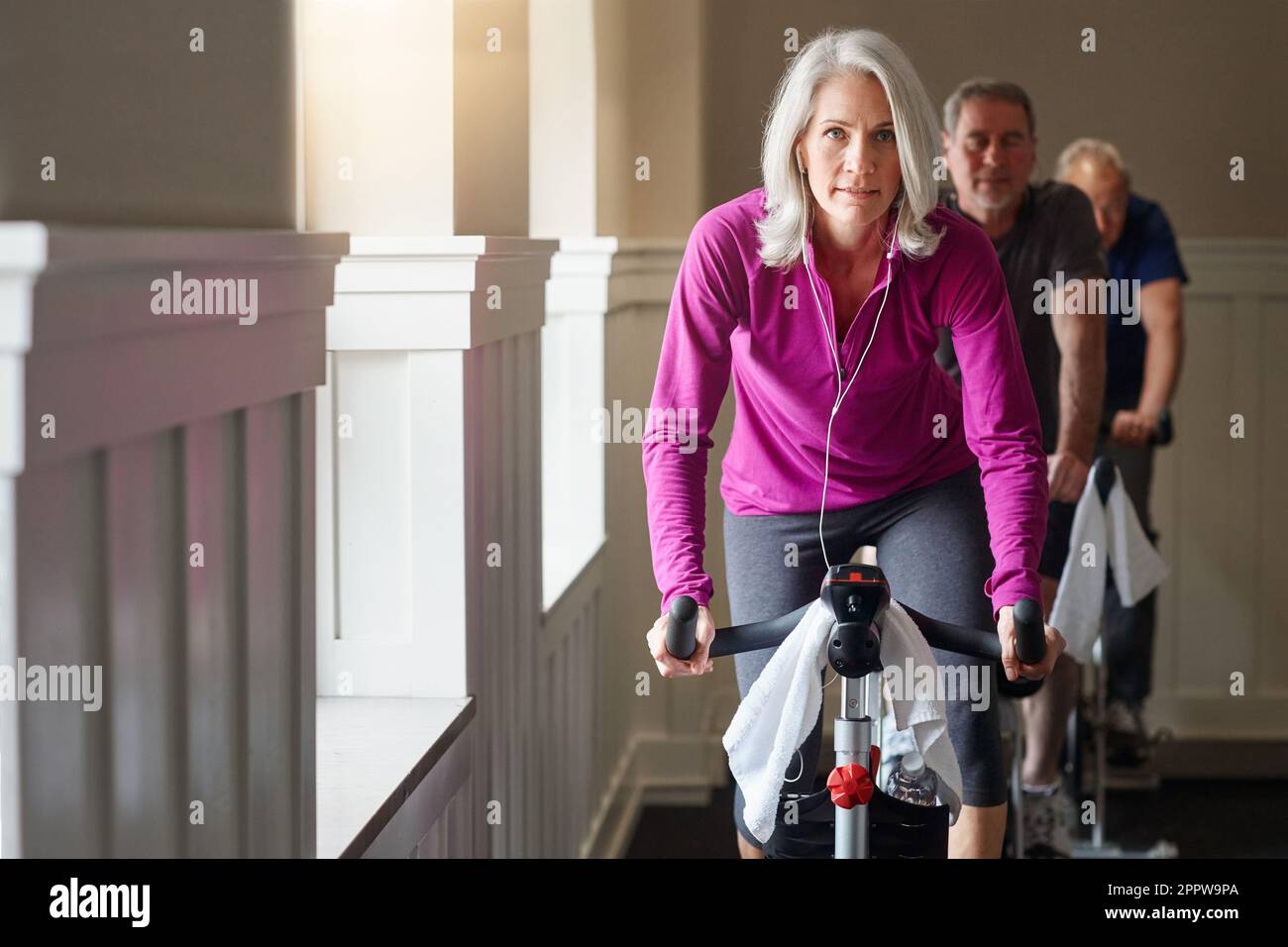 Spin is in for any age. a group of seniors having a spinning class at ...