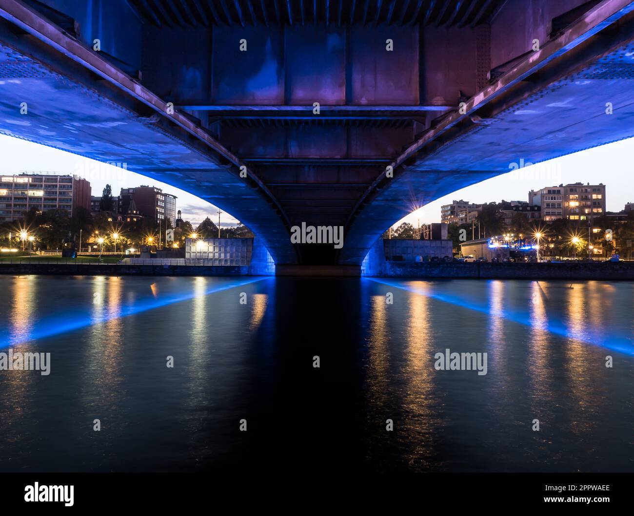A city skyline illuminated by blue lights located beneath a large ...