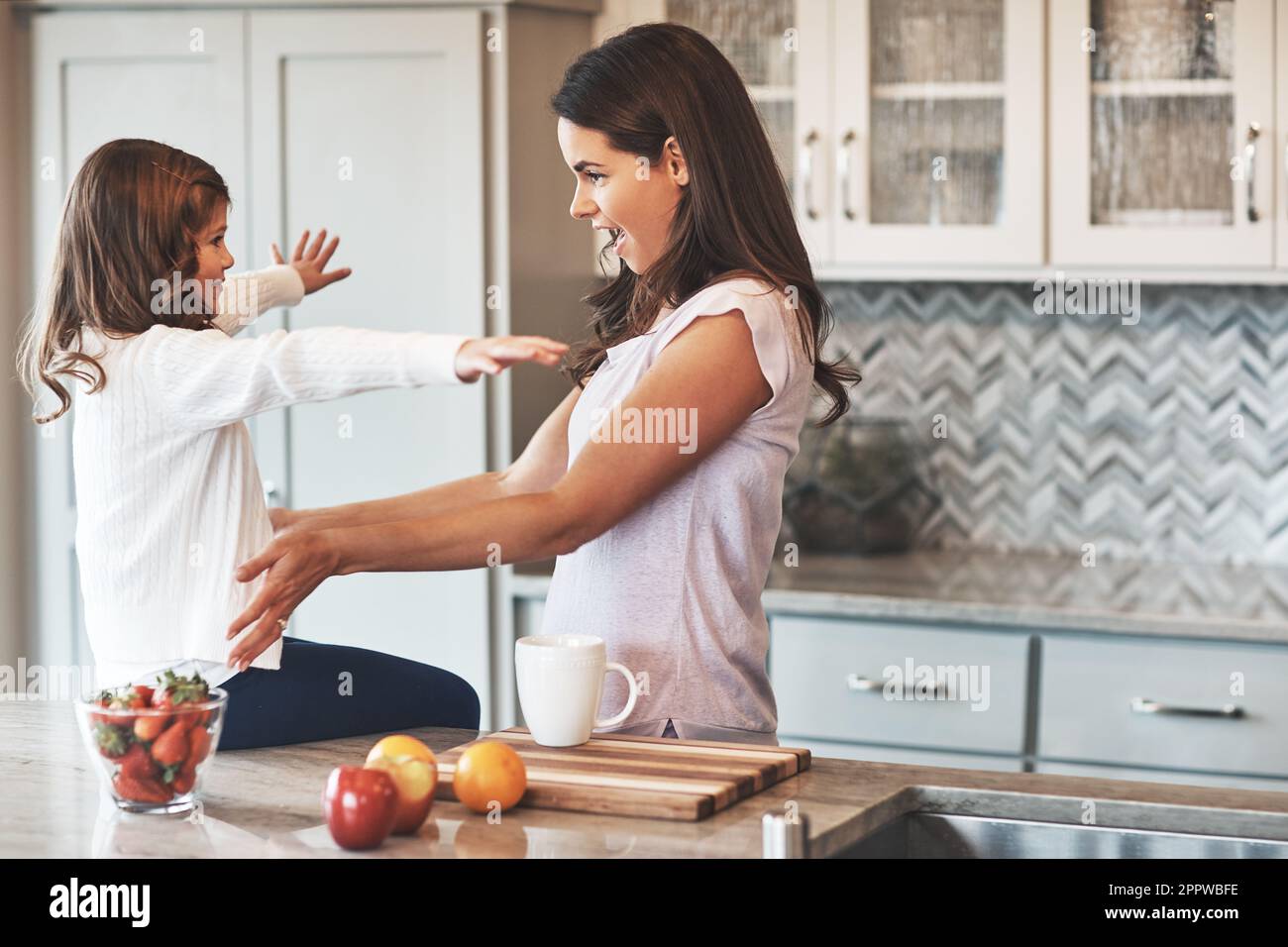 Can mommy get a hug. a happy little girl reaching out to hug her mother ...