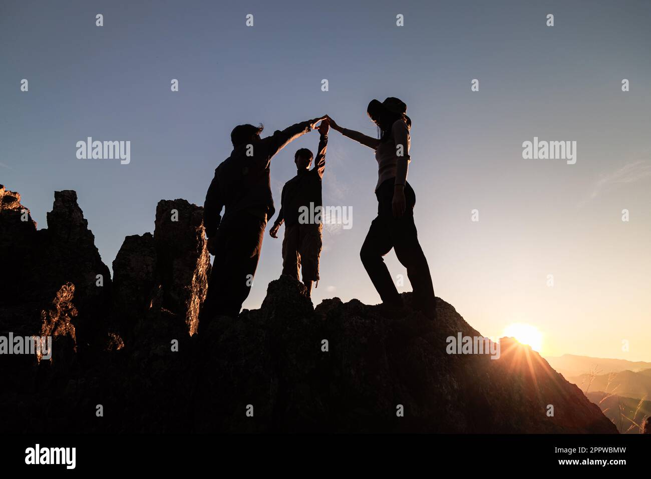 Silhouette of happy teamwork hold hands up as a business successful ...