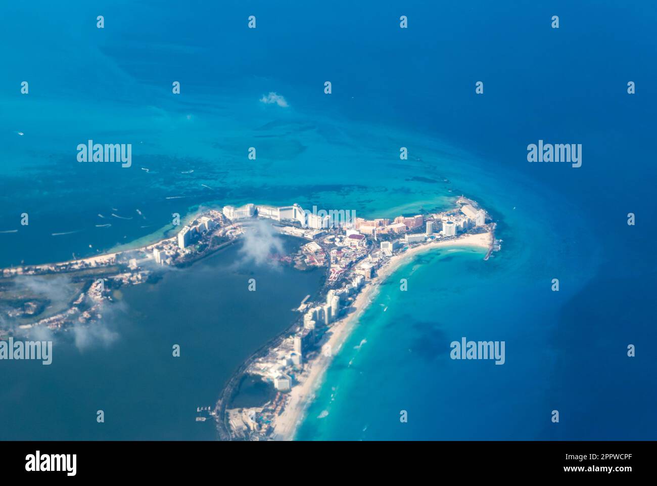 Aerial view through plane window of Caribbean coastline buildings in ...