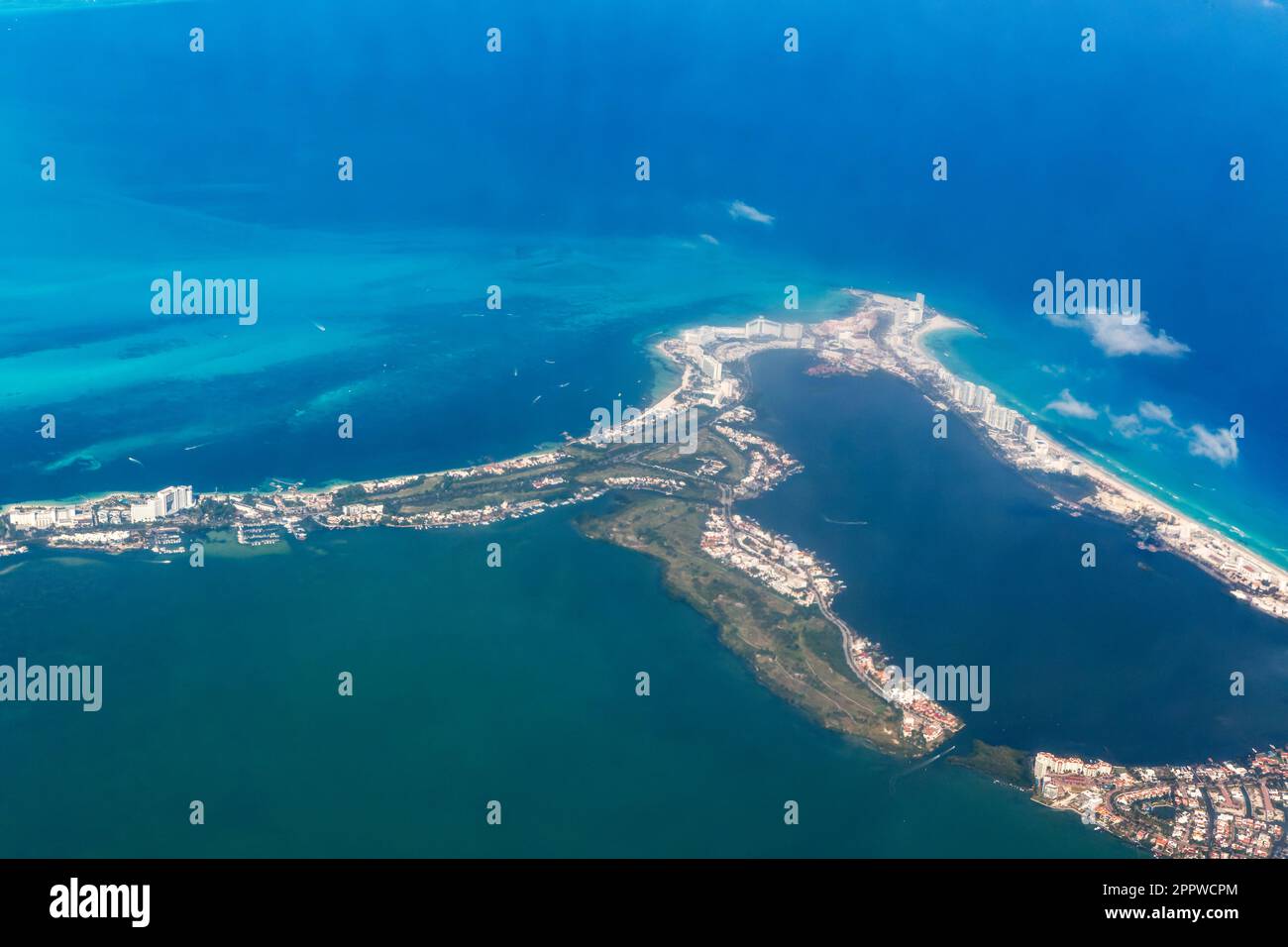 Aerial view through plane window of Caribbean coastline buildings in ...