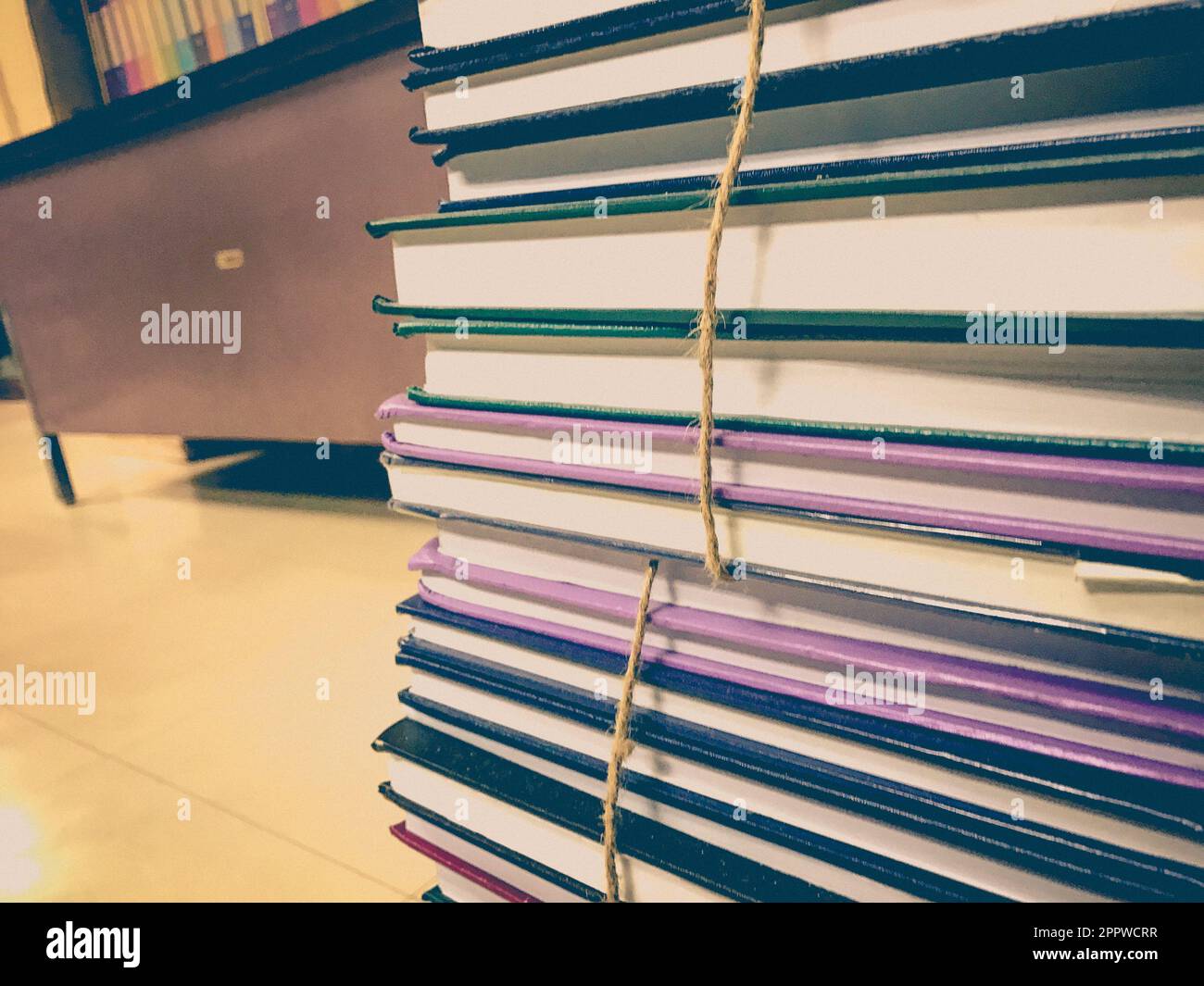 Pile of old books with rope background Stock Photo - Alamy