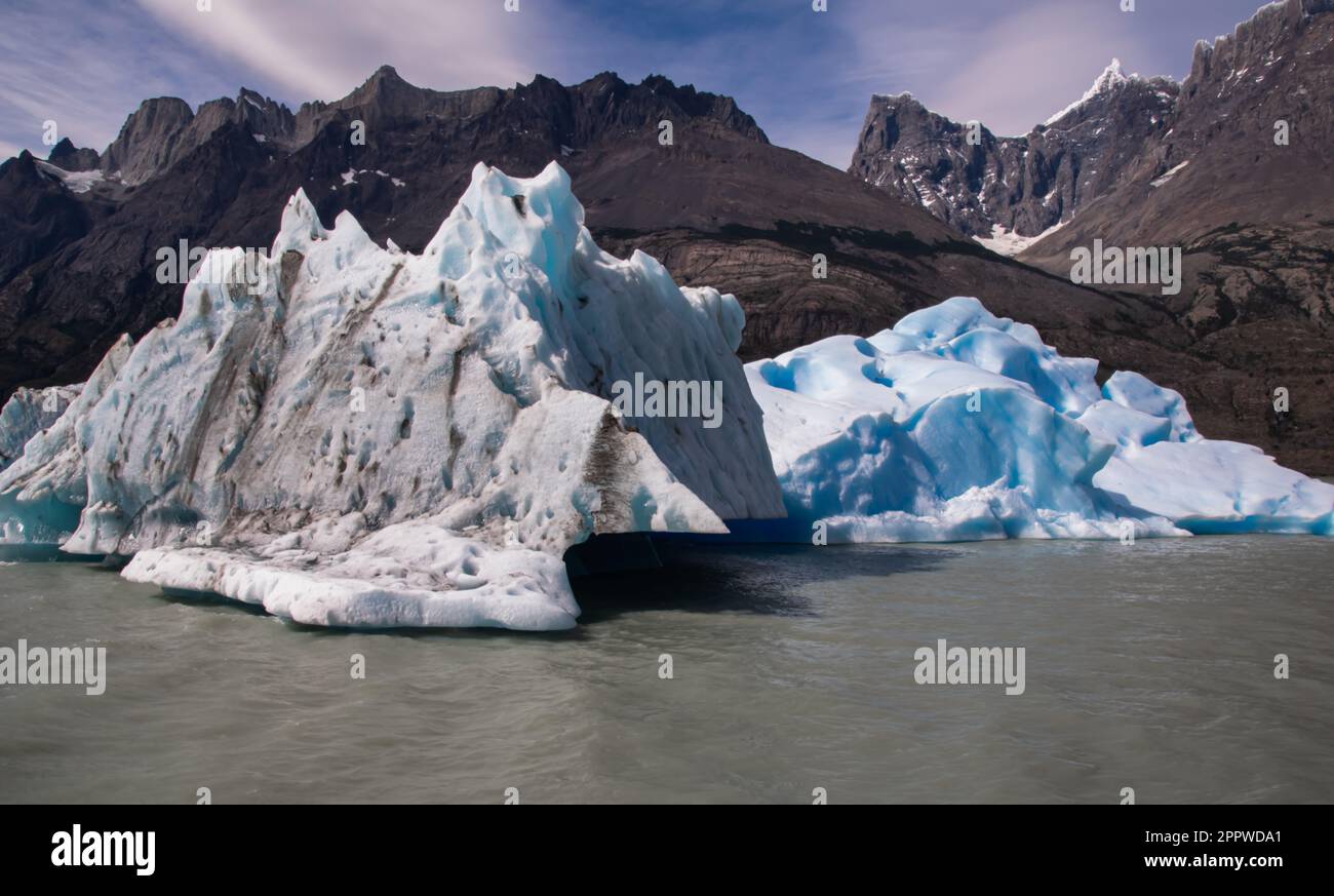 A majestic iceberg in the middle of an aquatic scene with snow-covered ...
