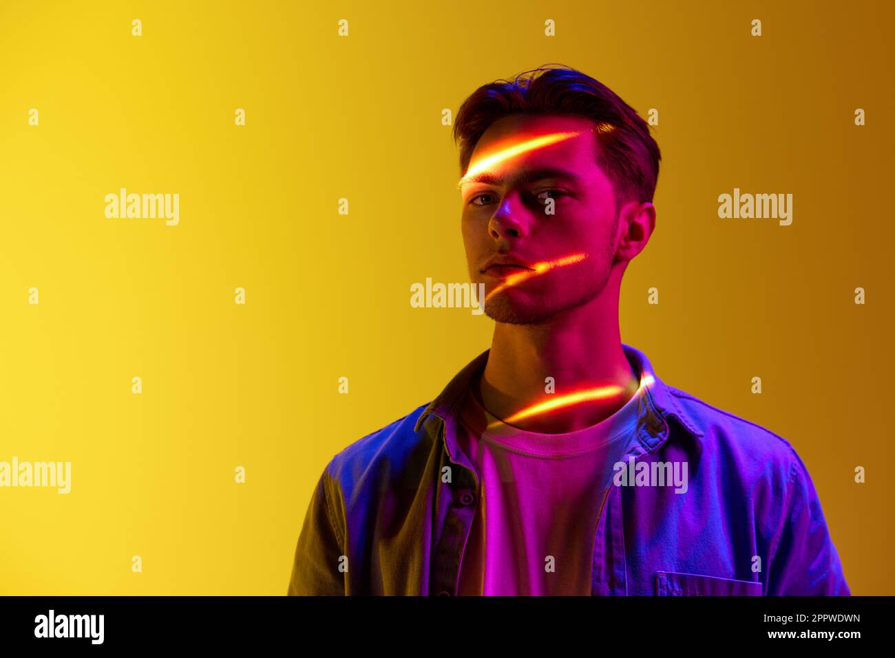 Handsome young man in casual stylish clothes with digital neon filter ...