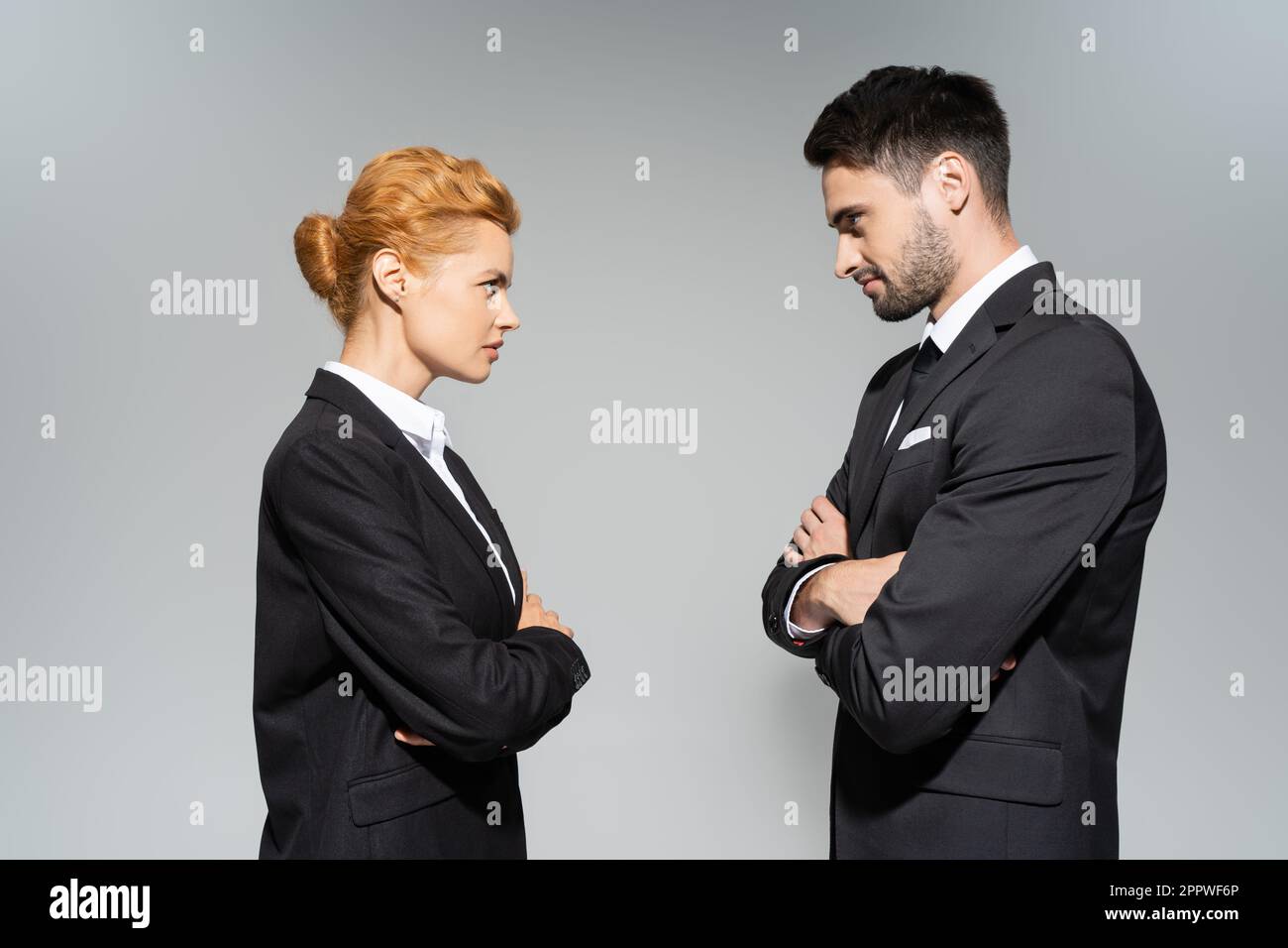 side view of angry business people looking at each other while standing ...